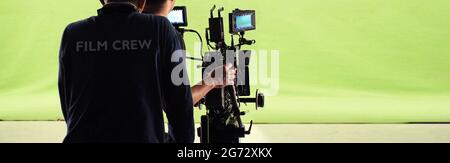Film Production. Back of videoographer and film crew team with 4k high ...