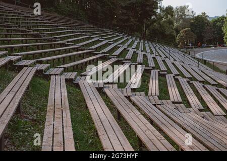 Empty wooden benches of the stadium Stock Photo - Alamy