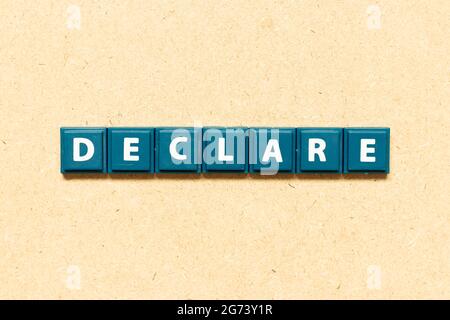 Tile alphabet letter with word mention in red color rack on wood ...