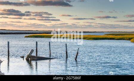 A view of the saltwater marshes with grasslands and breakwater in the ...
