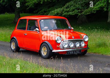 The front view of an old classic Mini Cooper in gray color on the ...