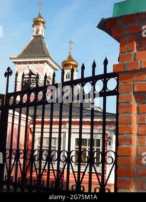 old wood temple bogorodskiy behind fence Stock Photo - Alamy