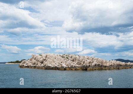 Small isolated rocky islet with seagulls in Adriatic sea, Croatia ...