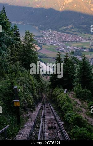 Red Funicular Train driving downhill from Harder Kulm, Top of ...