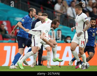 Italy's Giorgio Chiellini (left) pulls back England's Bukayo Saka ...
