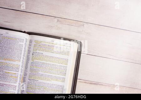 A Used and Highlighted Bible Open on a White Wood Table Stock Photo - Alamy