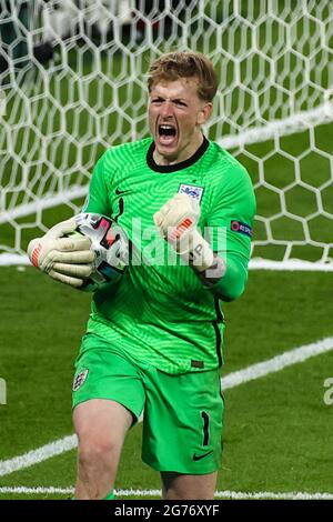 England goalkeeper Jordan Pickford celebrates after team-mate Ollie ...