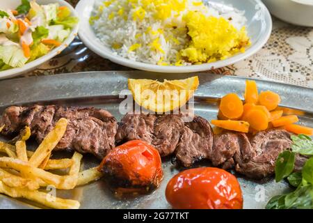 Traditional Persian Dish of Kebab and rice on wooden Table Stock Photo ...