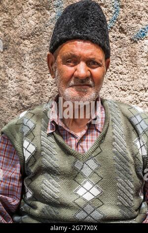A man sits under the shade of a tree at Steele Indian School Park in ...