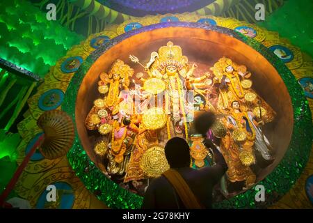 KOLKATA , INDIA - OCTOBER 1, 2014 : Priest praying to Goddesss Durga ...