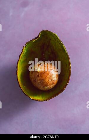 half empty avocado with pulp removed and only pip and skin remaining ...