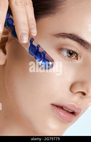 Cosmetic ampoule, a woman in the beauty salon, vitamin C in cosmetic ...