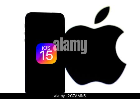 In this photo illustration the iOS 15 logo seen displayed on a ...