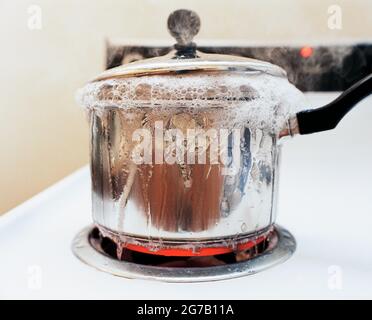 steam over cooking pot on a red background Stock Photo - Alamy