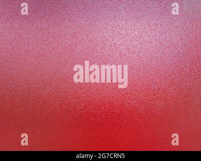 full frame bacground of red shagreen powder paint coating on flat sheet ...