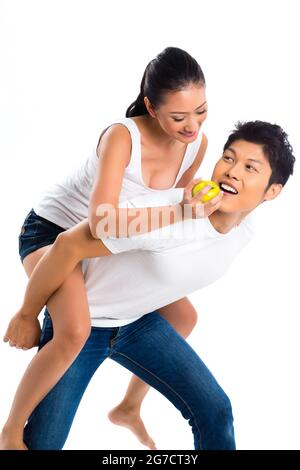 Chinese young woman wearing sportswear and towel looking to side, relax ...