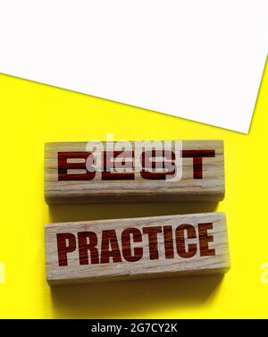 best practice words on wooden blocks on yellow. Business and healthcare ...