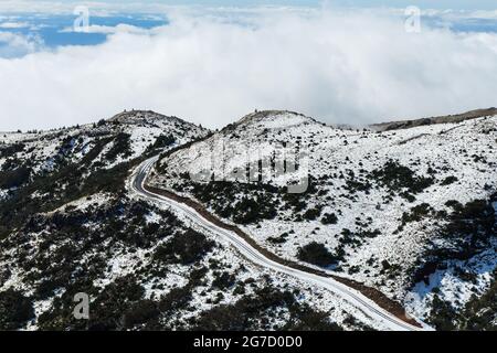 Road to Pico do Areeiro mountain covered with snow in Madeira island ...