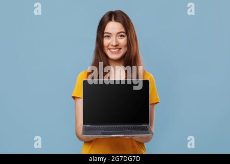 pretty millennial lady playing computer games, showing smartphone Stock ...