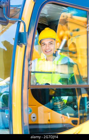 The cockpit of a digger Stock Photo - Alamy