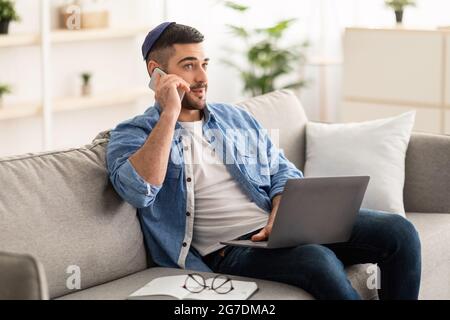 Portrait of israeli man talking on phone using pc Stock Photo - Alamy
