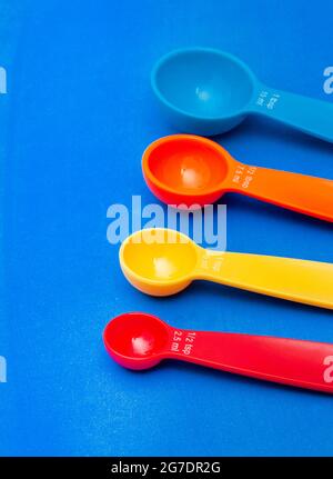 Set of colorful plastic measuring spoon isolated on white background ...