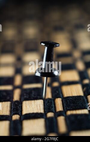Closeup shot of black pushpins on a black surface Stock Photo - Alamy