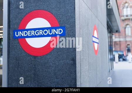 London underground sign, red circle with UNDERGROUND written in white ...