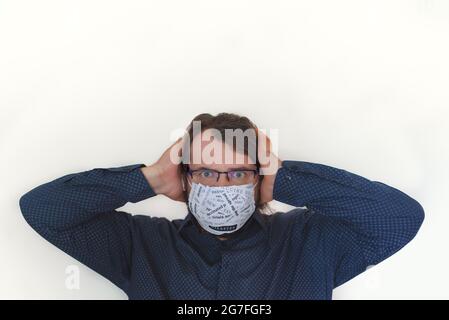 A clueless man with a face mask covered with news headlines related to ...