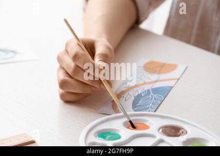 Woman drawing on bookmark at table, closeup Stock Photo - Alamy