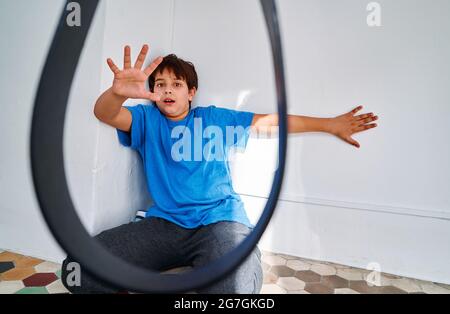 Helpless scared preteen boy sitting in corner while anonymous parent ...