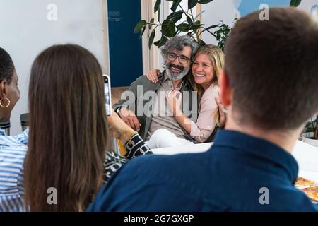 Group of positive diverse coworkers in trendy clothes standing in ...