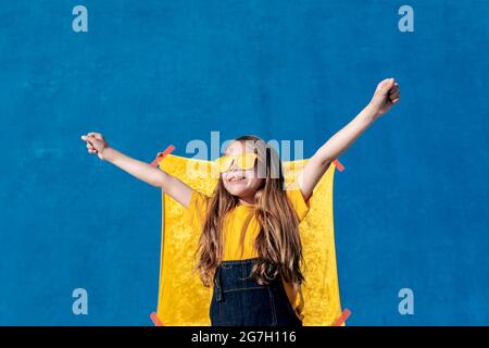Content teen hipster in sunglasses and with long hair standing with ...