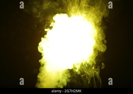 Artificial yellow light illuminates smoke on dark background Stock ...