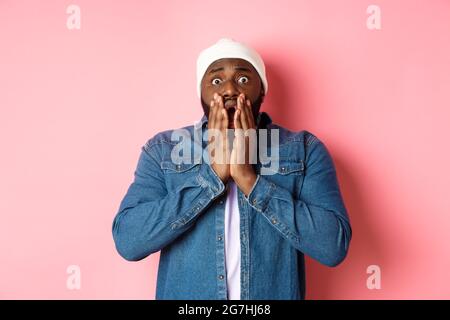 Alarmed and worried Black man staring at bad accident, gasping and ...