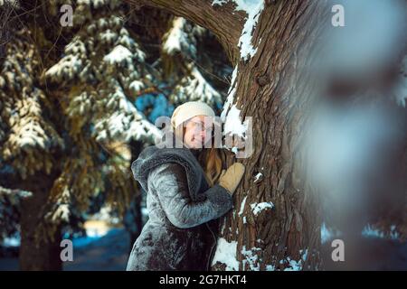 Happy woman throws snow in winter Stock Photo - Alamy