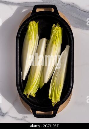chicory in cast iron roasting dish Stock Photo - Alamy