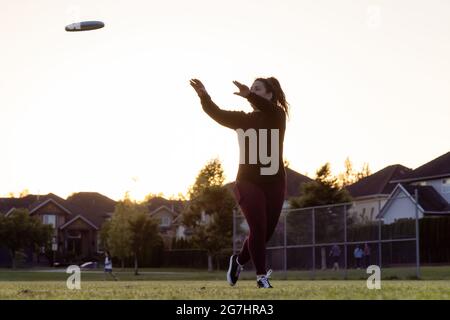 White Caucasian Adult Girl Playing Frisbee in the Green Field Stock ...