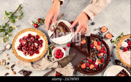Different types of homemade tarts on light gray background. Top view ...