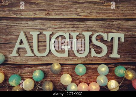 August alphabet letter with LED cotton balls on wooden background Stock ...