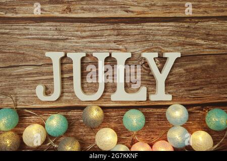 August alphabet letter with LED cotton balls on wooden background Stock ...