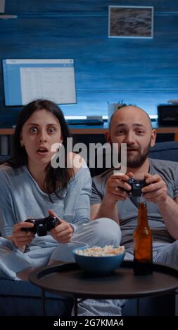 Determinated enthusiastic couple winning video games, hugged each other ...