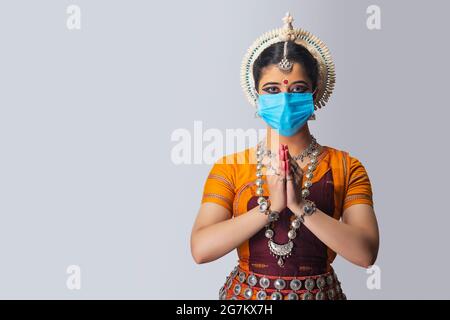 Odissi dancer wearing a mask Stock Photo - Alamy
