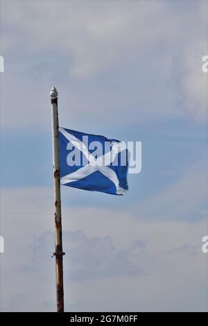 Tattered Scottish flag on rusty pole Stock Photo - Alamy