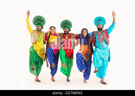 A Troupe of Punjabi Folk dancers dressed in costume with Dhol,Khunda ...