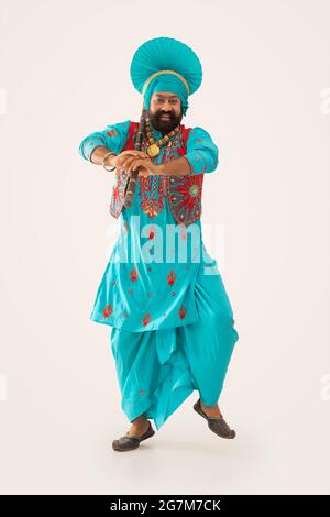 A Bhangra Dancer performing with Khunda Stock Photo - Alamy