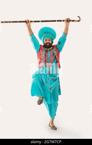 A Bhangra Dancer performing with Khunda Stock Photo - Alamy