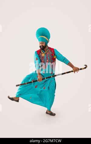 A Bhangra Dancer performing with Khunda Stock Photo - Alamy