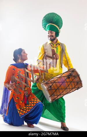 A Bhangra and A Giddha Dancer Performing with a Dhol and Khunda Stock ...