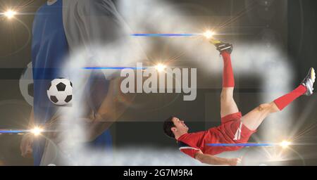 Smoke effect over two male soccer players against spot of lights on ...